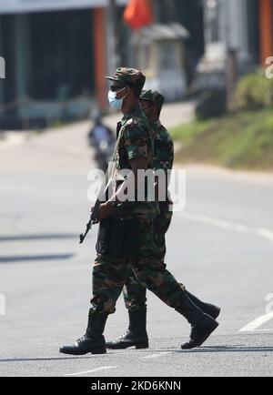 Sri Lankan Army soldiers cross the road near a checkpoint after ...