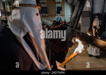 The first crucifer in procession with a heavy cross on his shoulders in ...