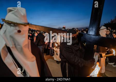 The first crucifer in procession with a heavy cross on his shoulders in ...