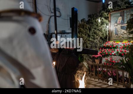 The first crucifer makes a bow at the church before entering to kneel ...