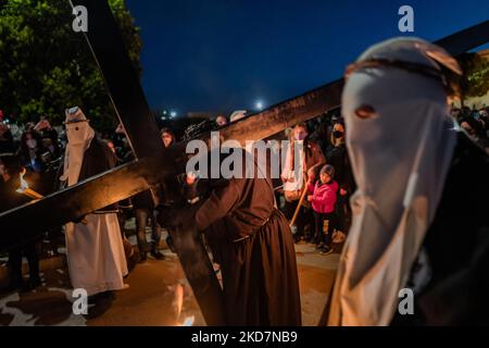 The first crucifer in procession with a heavy cross on his shoulders in ...