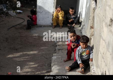 Palestinian children sitting in front of their house in a poor ...