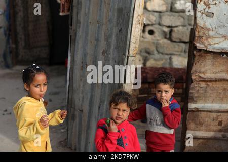 Palestinian children are seen next their house in a poor neighborhood ...