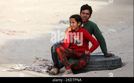 Palestinian children are seen next their house in a poor neighborhood ...
