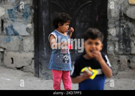 Palestinian children are seen next their house in a poor neighborhood ...