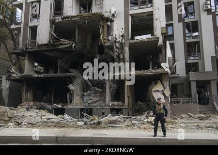 A Ukrainian serviceman stands amid destroyed Russian tanks in Bucha, on ...