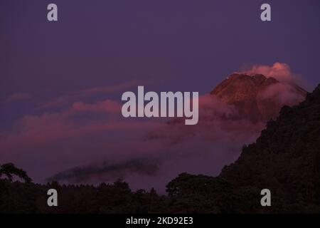 The scenery of Mount Merapi volcano by sunset is seen from Turgo ...