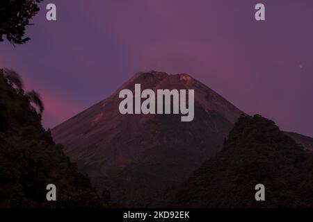 The scenery of Mount Merapi volcano by sunset is seen from Turgo ...