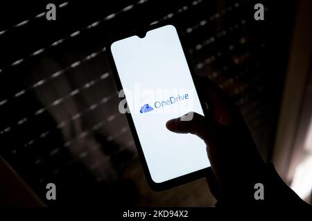 In this photo illustration a OneDrive logo seen displayed on a ...