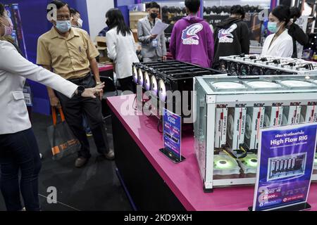Visitors inspect crypto mining equipment at the Thailand Crypto Expo in ...