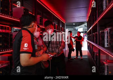 Visitors inspect crypto mining equipment at the Thailand Crypto Expo in ...