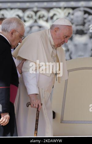Pope Francis uses a walking stick to leave at the end of his weekly ...