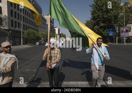 Iranian Basiji (Members of Basij Paramilitary force) men carrying ...