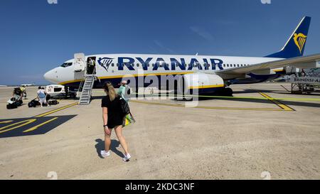 People deplane from a a Ryanair Boeing 737-800 landed in Brindisi ...