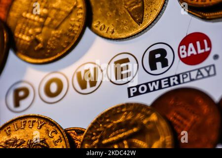 Powerball logo displayed on a phone screen and Powerball website ...