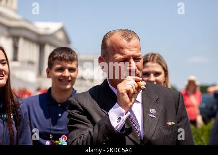 Rep. Troy Nehls (R-Texas) smokes a cigar while speaking with reporters ...