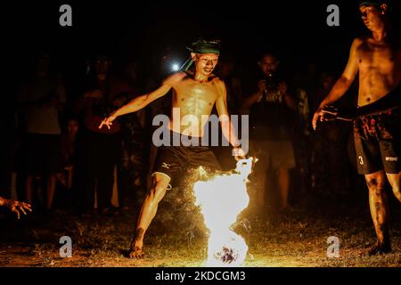 Villagers playing fire football, known locally as "sepak bola api", a ...