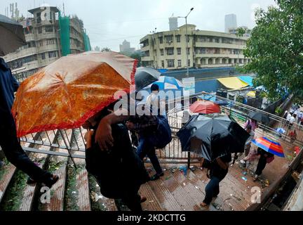 People carry colourful umbrellas during heavy rainfall in Mumbai, India ...