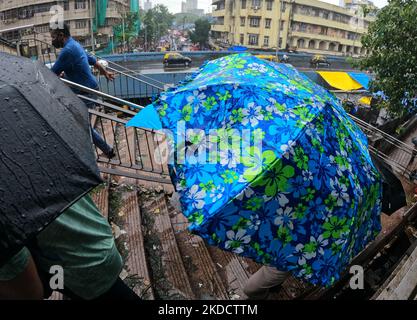 People carry colourful umbrellas during heavy rainfall in Mumbai, India ...