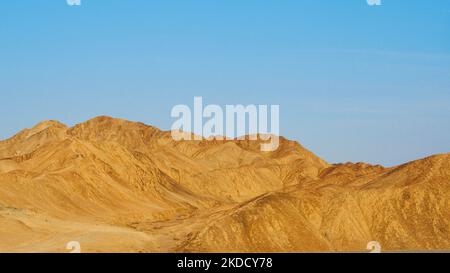 A low-angle of sunlit hills in the horizon, clear sky background Stock ...