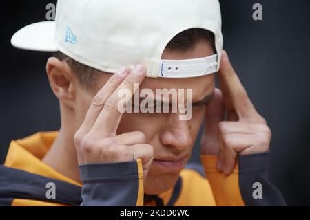 McLaren driver Lando Norris of Britain stands in the pit during a ...