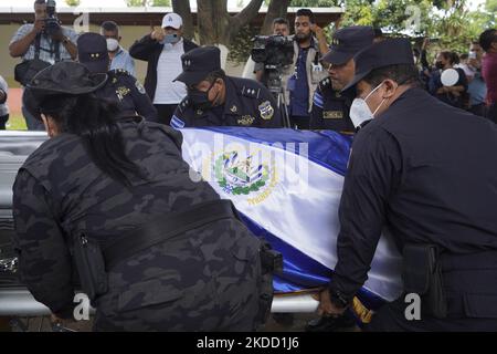 Police Officers carry the casket in during the start of a funeral for ...
