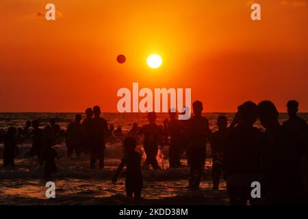 Palestinians swim and play with ball in Gaza Beach on a hot day and ...