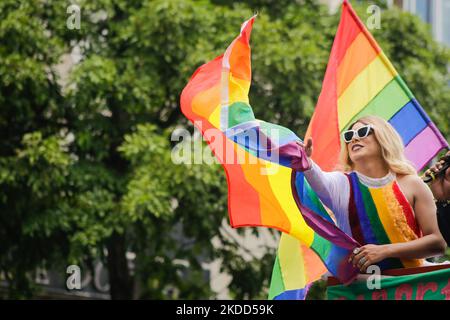 An activist waves an LGBTIQ+ flag during the pride march in Caracas ...