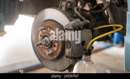 Automatic change of brake fluid in a car service Stock Photo - Alamy