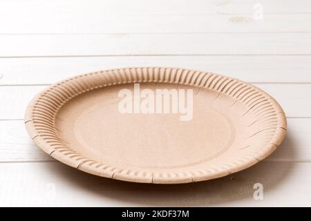 Perspective view of eco paper plate on cement background. Empty space ...