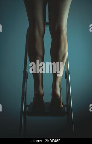 Rear view of a barefooted woman standing on the floor Stock Photo - Alamy