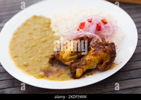 Peruvian dish. chicken wings with pea puree, rice and pickled onions ...