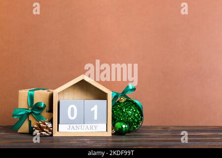 1 january. Christmas composition on colored background with a wooden ...