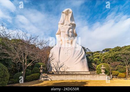 Japan, Kanagawa, Kamakura, Ofuna Kannon and Ofuna Station at dawn ...