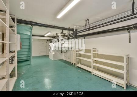 Storage room with pipes and metering devices. A long room with ...