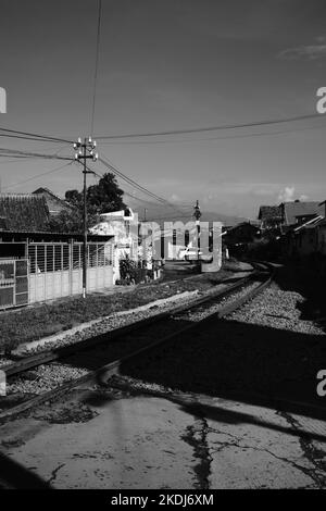 Railroad track in a residential area at sunset Stock Photo - Alamy