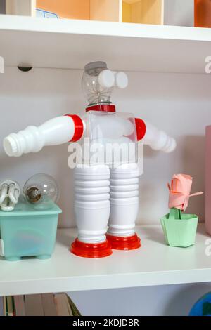 Recycled toy robot made with plastic packages and lightbox with ecology ...