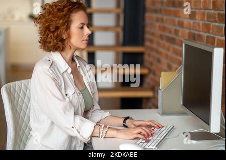 Ginger self-emplpoyed woman working in the office Stock Photo - Alamy