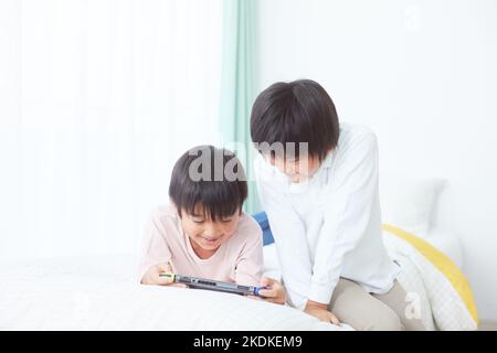 Japanese kids playing games at home Stock Photo - Alamy