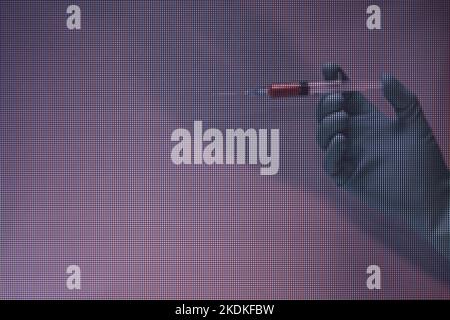 Beautiful hand holding creative syringe with red vaccine in the neon ...