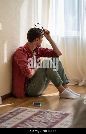 the tired European young man looks dejectedly, without strength and ...