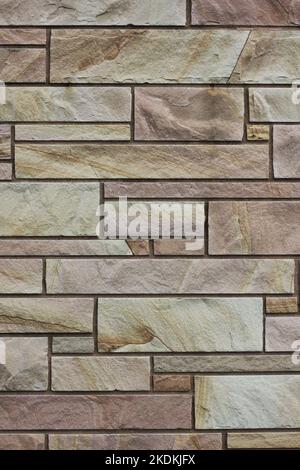 Solid brick wall created with natural stone bricks in a random pattern ...