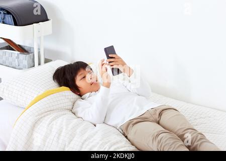 Japanese kid using smartphone at home Stock Photo - Alamy