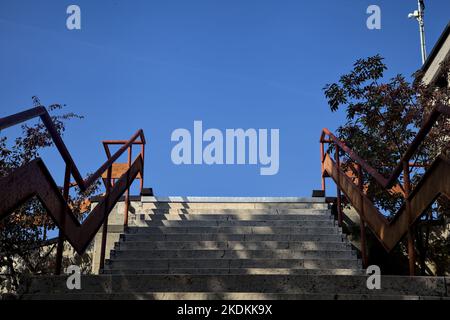Staircase with red rails with the sky on the top of it Stock Photo - Alamy