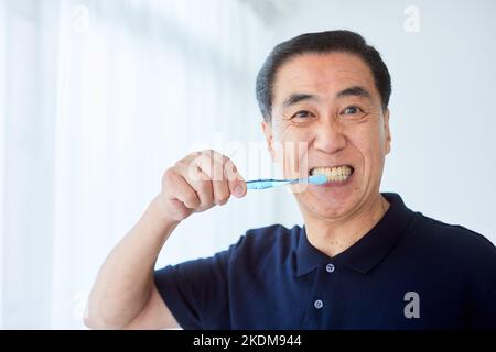 Japanese senior man brushing teeth Stock Photo - Alamy