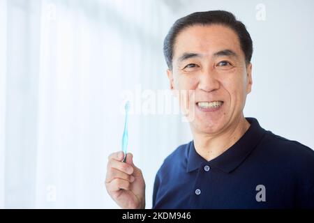 Japanese senior man brushing teeth Stock Photo - Alamy