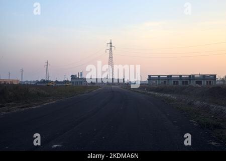 Abandoned warehouses and pylons next to a roundabout in an industrial ...
