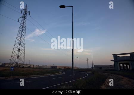 Abandoned warehouses and pylons next to a roundabout in an industrial ...