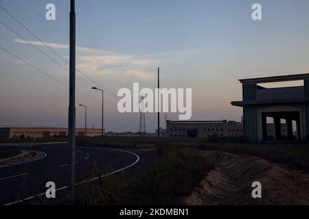 Abandoned warehouses and pylons next to a roundabout in an industrial ...