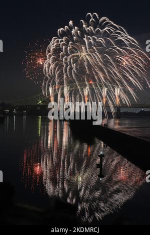 Relections in the Manchester Ship Canal of the exploding fireworks ...